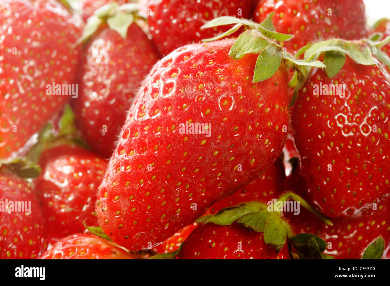Big ripe strawberry placed at the top of other strawberries Stock Photo ...