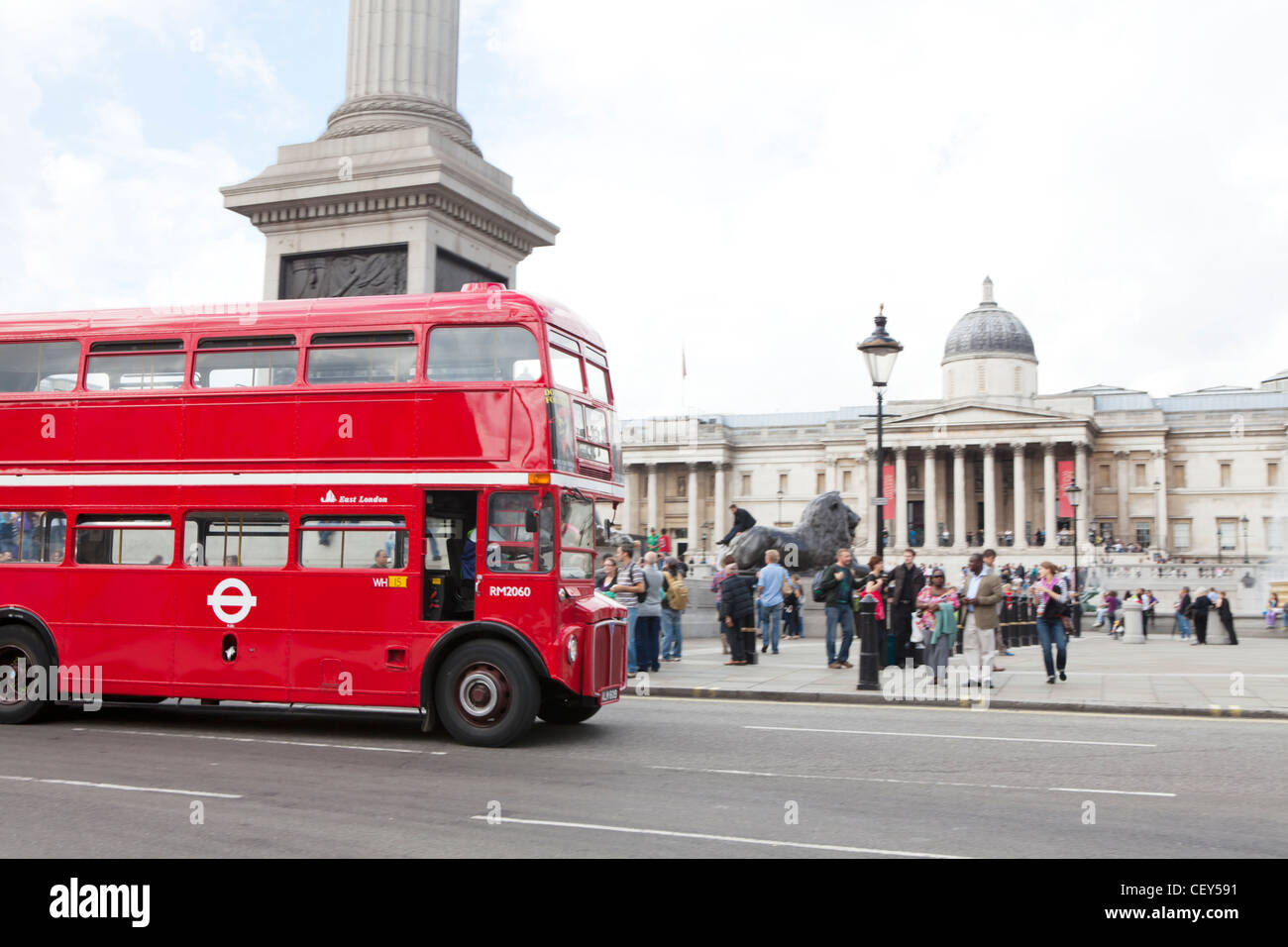 A view of a red bus as it passes in front of the National Portrait ...