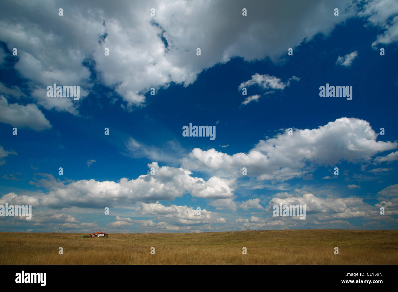 Landscape with house, blue sky and clouds Stock Photo - Alamy