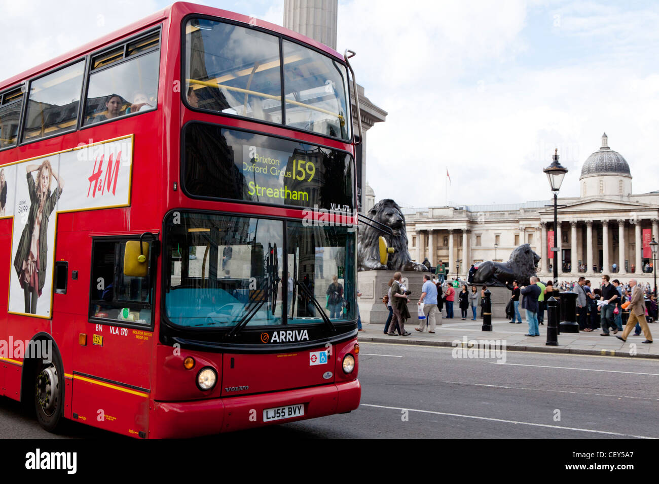 A view of a red bus as it passes in front of the National Portrait ...
