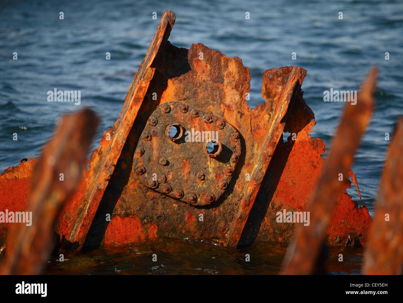Rusty steel remains from an old ship appear over the sea surface Stock ...