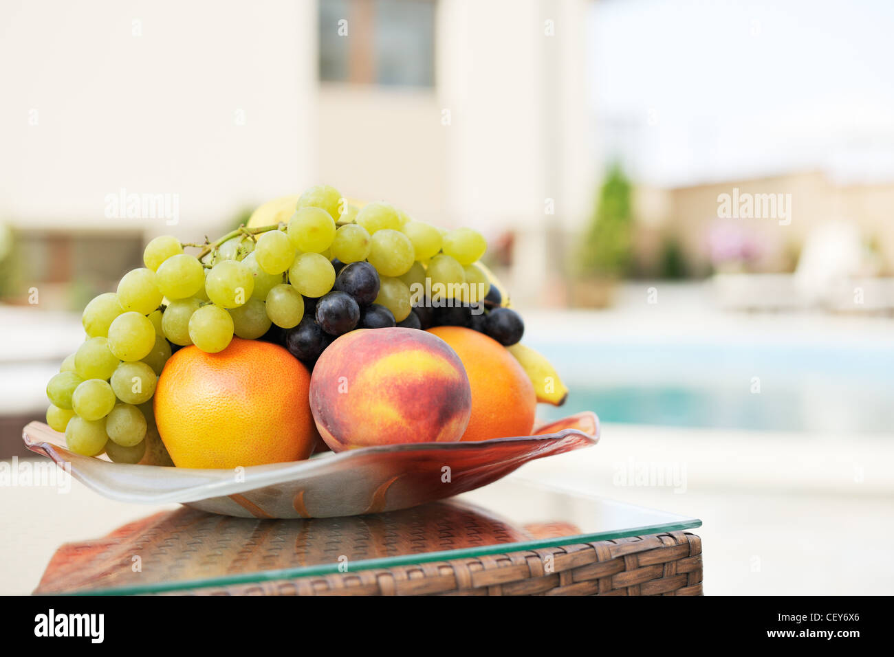 Ripe summer fruits on table near swimming pool Stock Photo - Alamy
