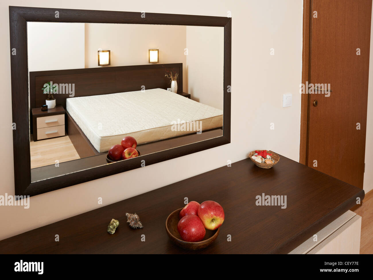 Apart hotel bedroom interior example mirror frame Stock Photo - Alamy