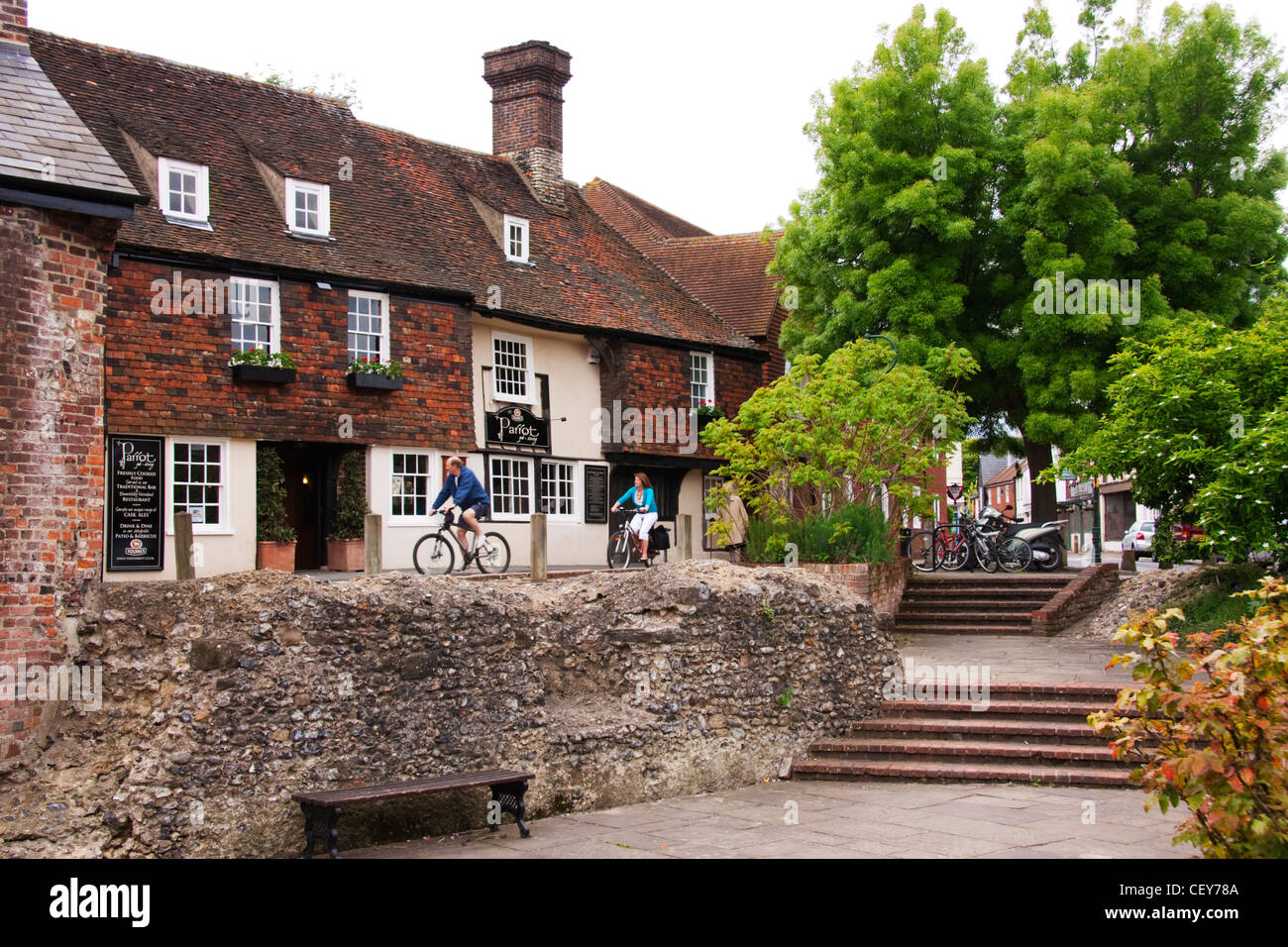 Two cyclists ride past the 14th Century Parrot pub in Canterbury, Kent ...
