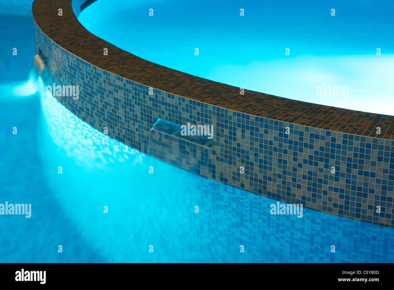 Blue lights of a small swimming pool at night Stock Photo - Alamy