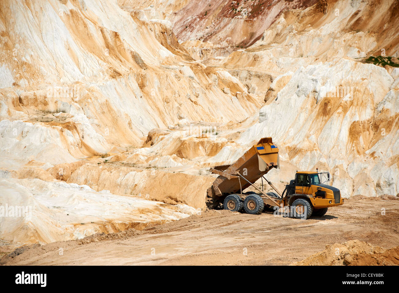 Limestone quarry with white material and truck Stock Photo - Alamy