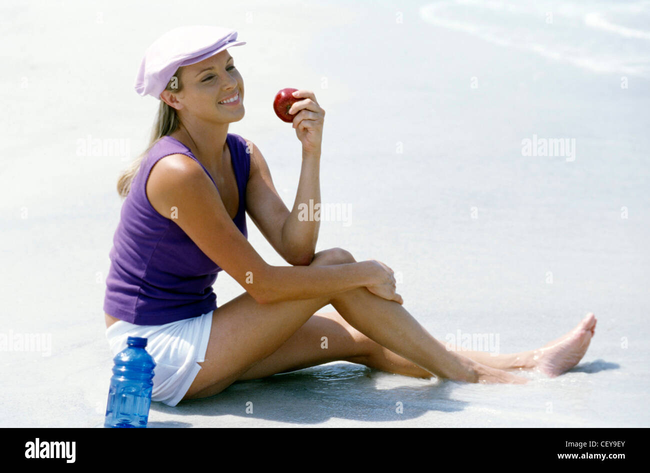 Female Long Straight Blonde Hair Wearing White Shorts Purple Vest Top
