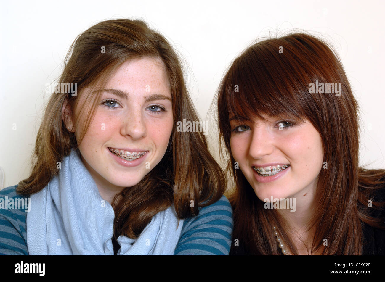 Two Female teenagers smiling to camera Stock Photo - Alamy