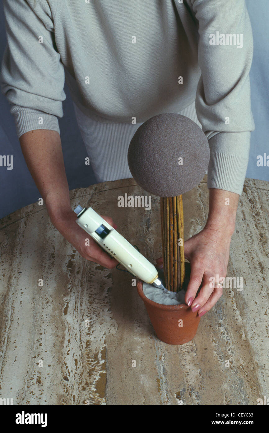 How to make a rose tree Step Use a glue gun to glue the twigs to the ...