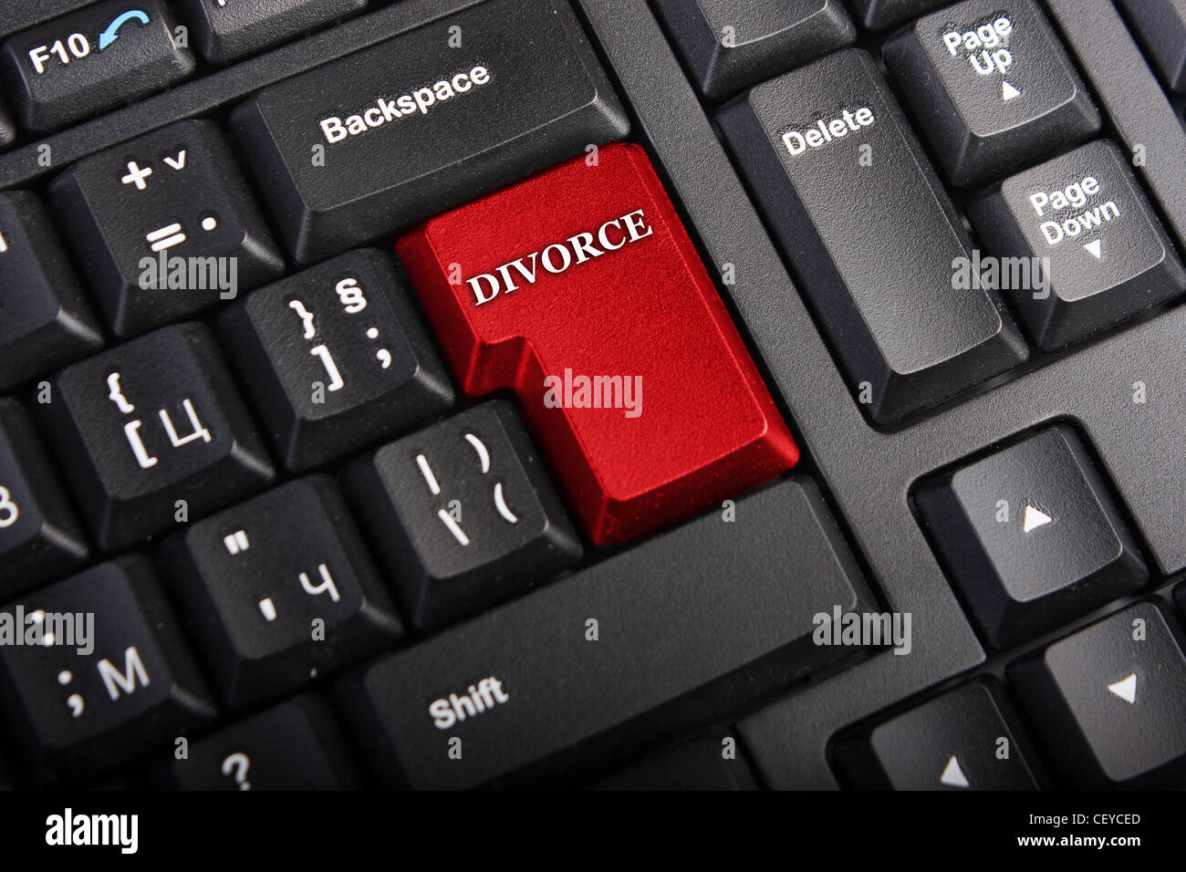 Keyboard with selective focus on the enter button saying DIVORCE Stock ...