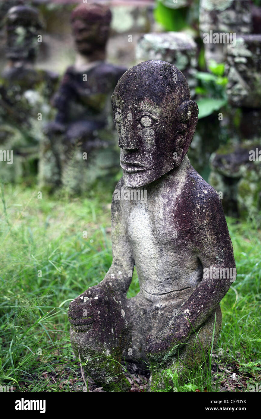 Stone Batak statues near King's grave at Tomok. Samosir Island, Lake ...