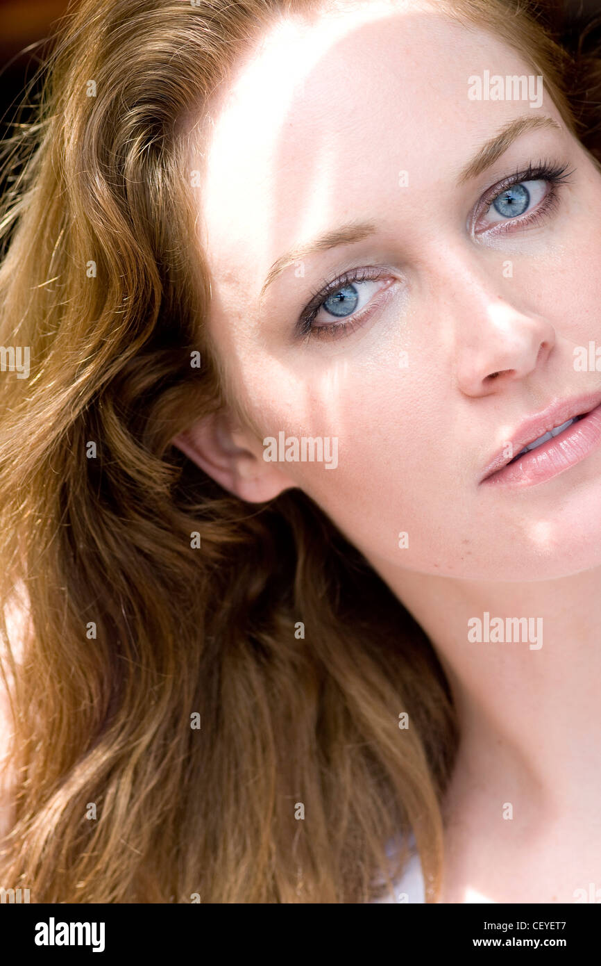 Female with fair wavy hair, wearing pale grey metallic eyeshadow, black ...