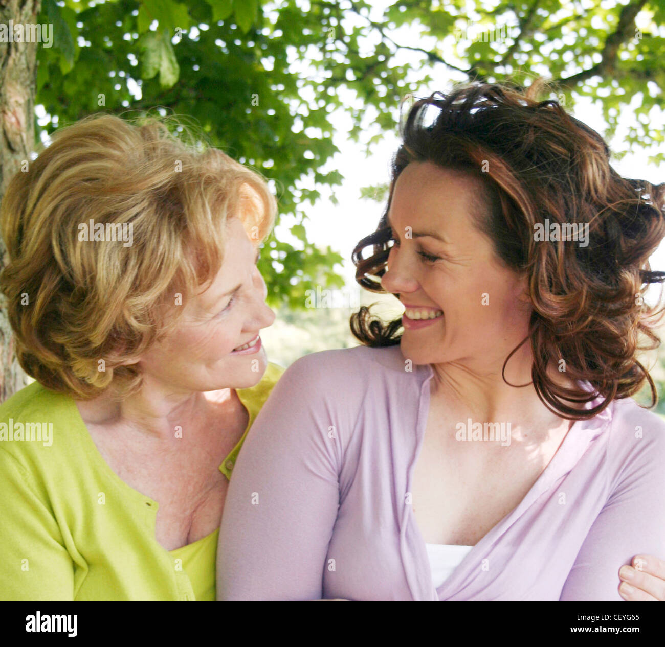 Female short fair hair, wearing a green top and cardigan, hugging her ...