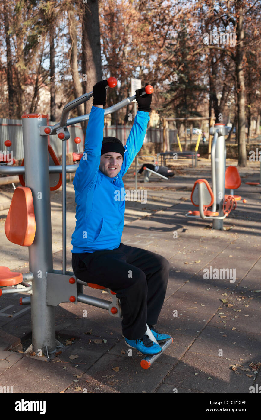 Man doing exercise outdoors in a public park Stock Photo - Alamy