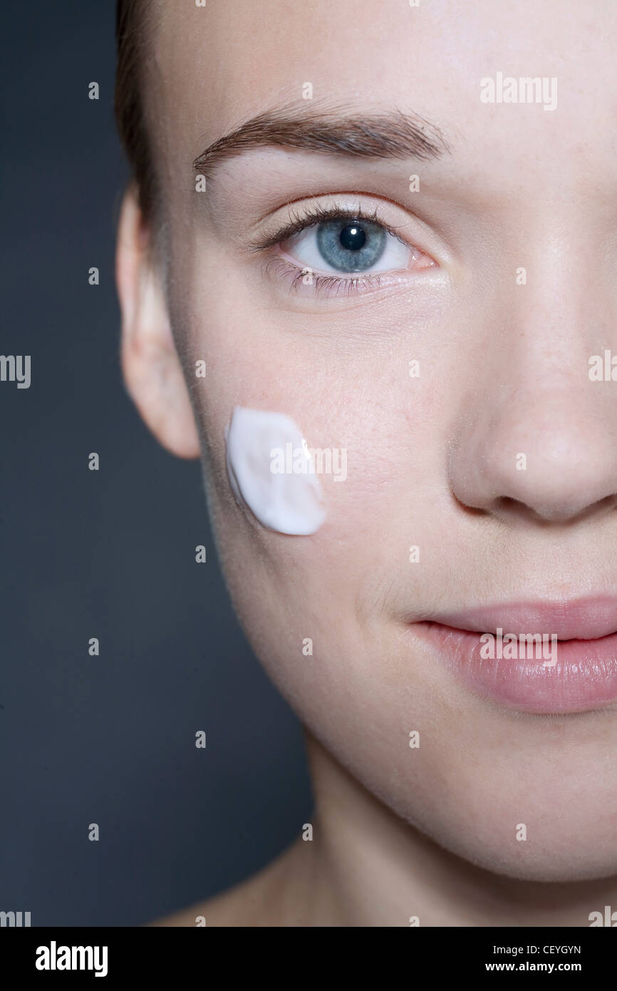 Step by Step Beauty and Make Up Female with face cream on her cheek ...