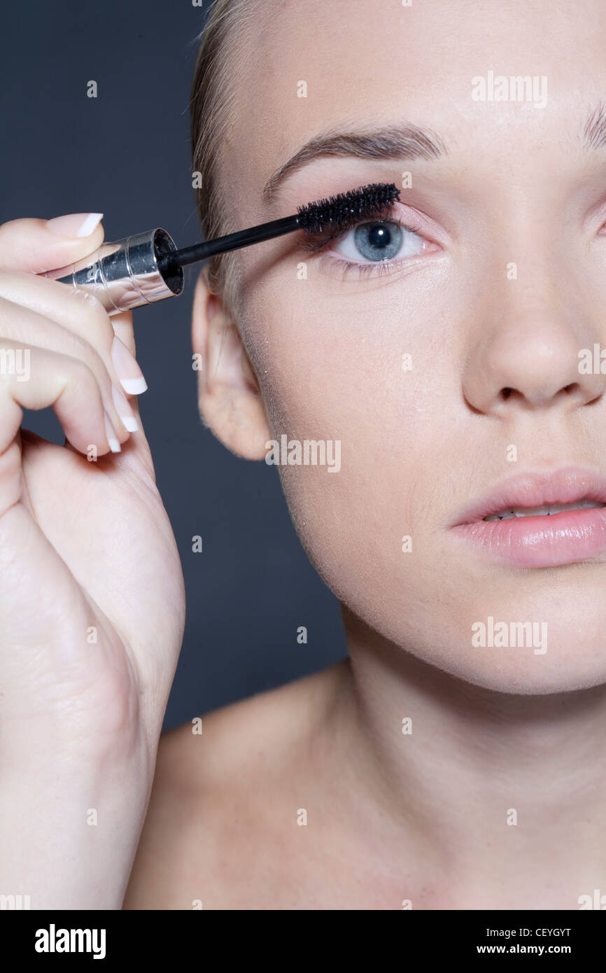 Step by Step Beauty and Make Up Female applying black mascara to her ...