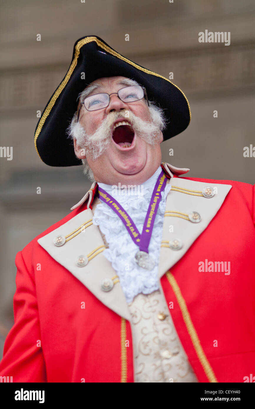 a traditional english town crier cryer in uniform Stock Photo - Alamy