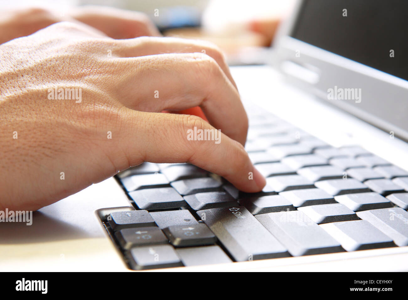 A pair of hands typing into a laptop computer Stock Photo - Alamy