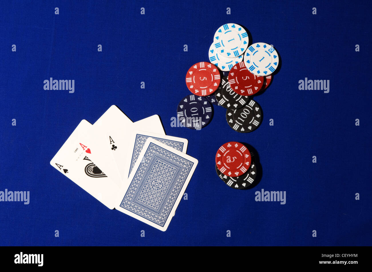 Poker hand layed out on blue background with two hidden cards and chips ...