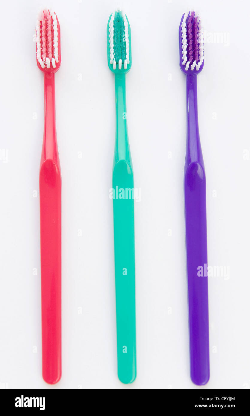 Red, green and purple toothbrushes in a row Stock Photo - Alamy