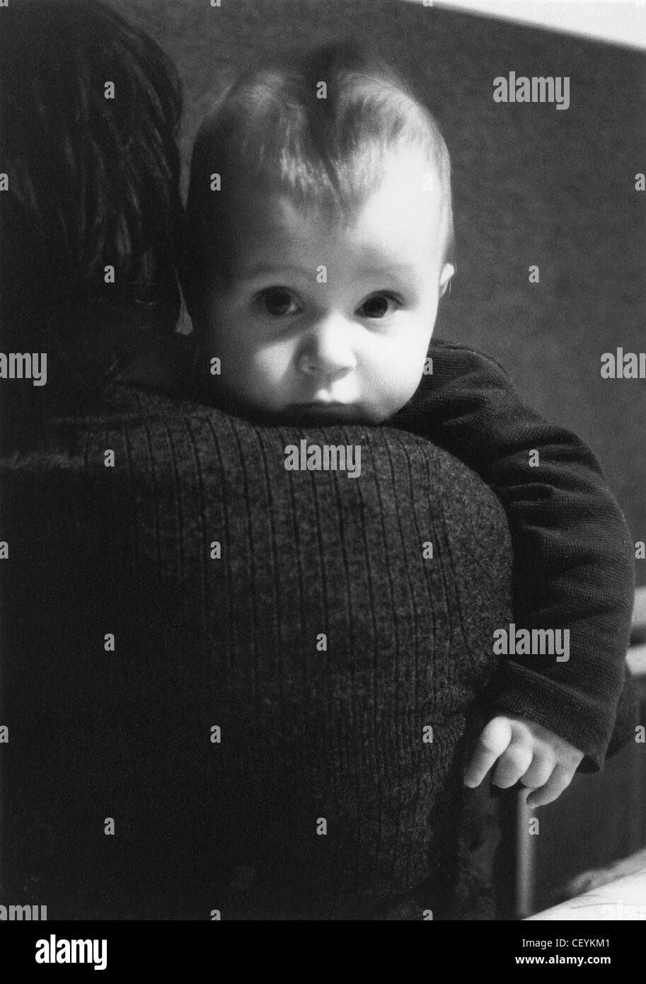 'FACES OF ALFI' Baby being carried by parent over shoulder looking to ...