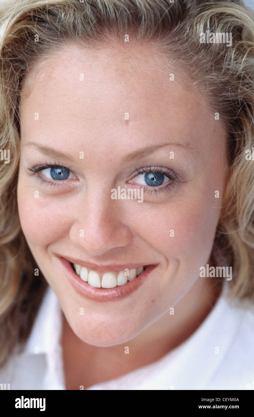 Female With Long Wavy Blonde Hair Wearing Subtle Make Up And White