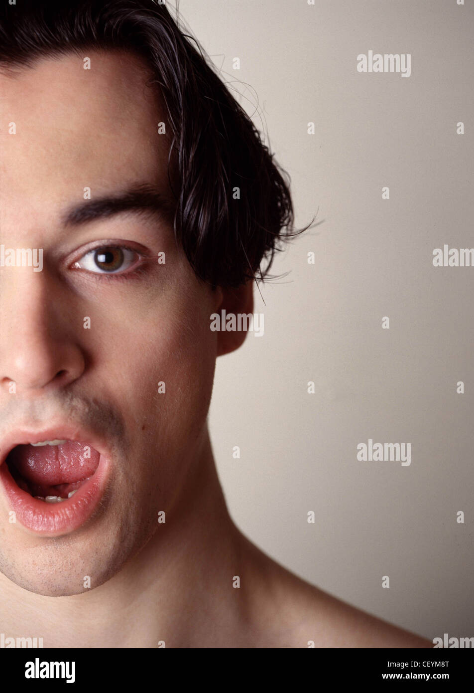 Cropped image of male medium length brown hair heavy eyebrows bare ...