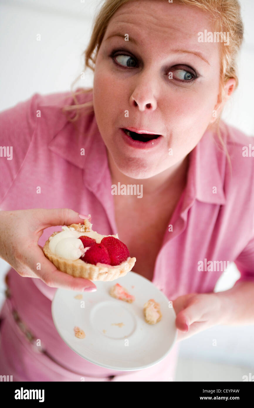 Woman stuffing food in her mouth hi-res stock photography and images ...