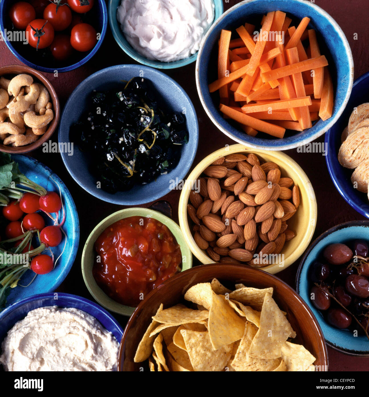 A selection of cold snacks and dips including carrots, almonds ...