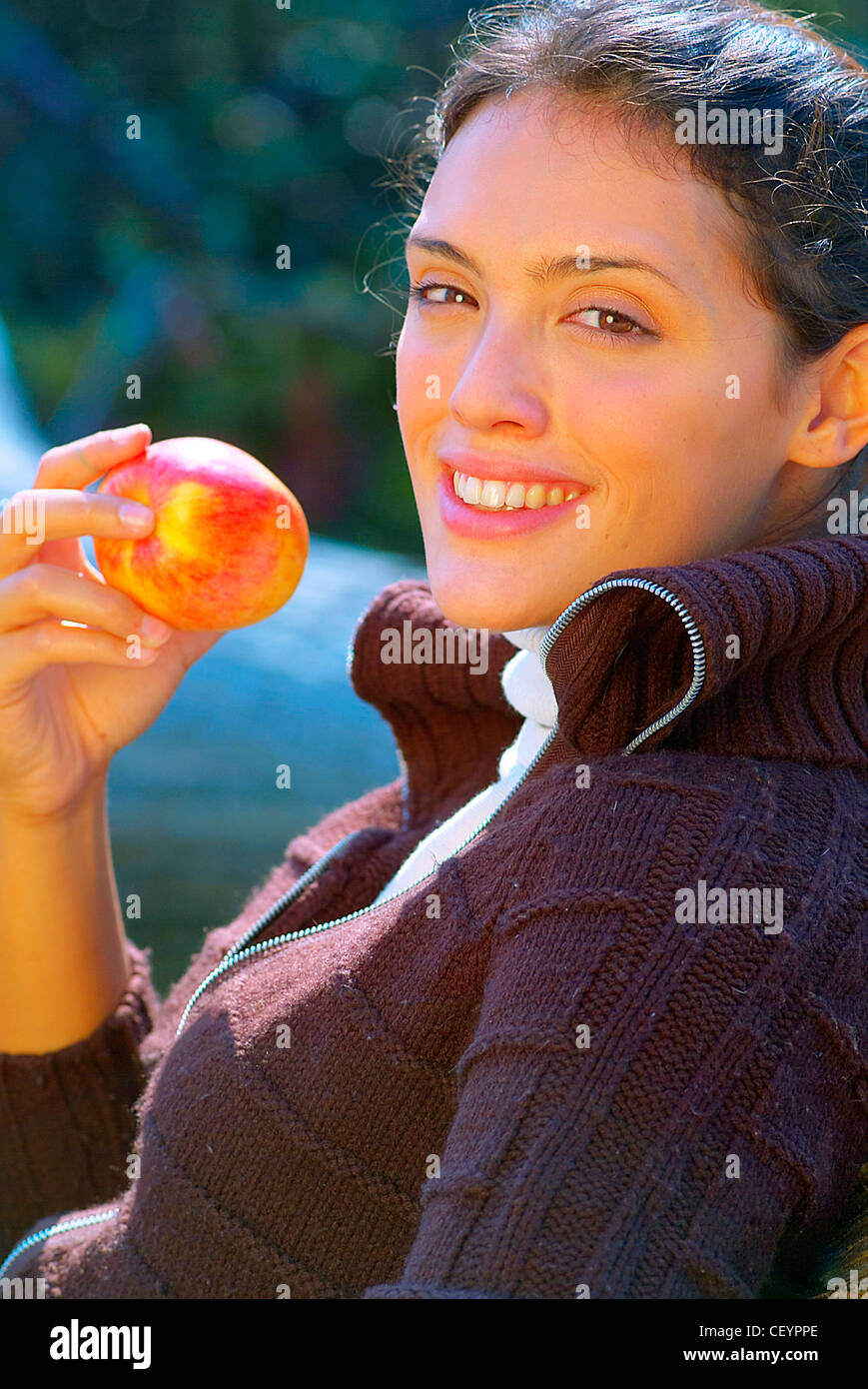 Brunette female, hair in a ponytail, wearing a cream polo neck under a ...