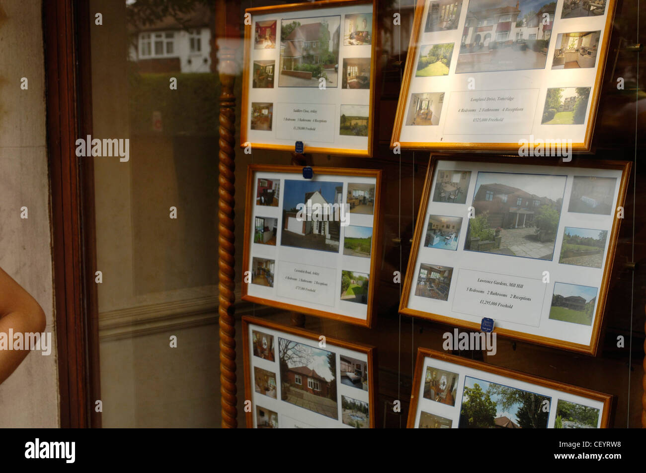 View of sales boards in window of estate agent Stock Photo - Alamy
