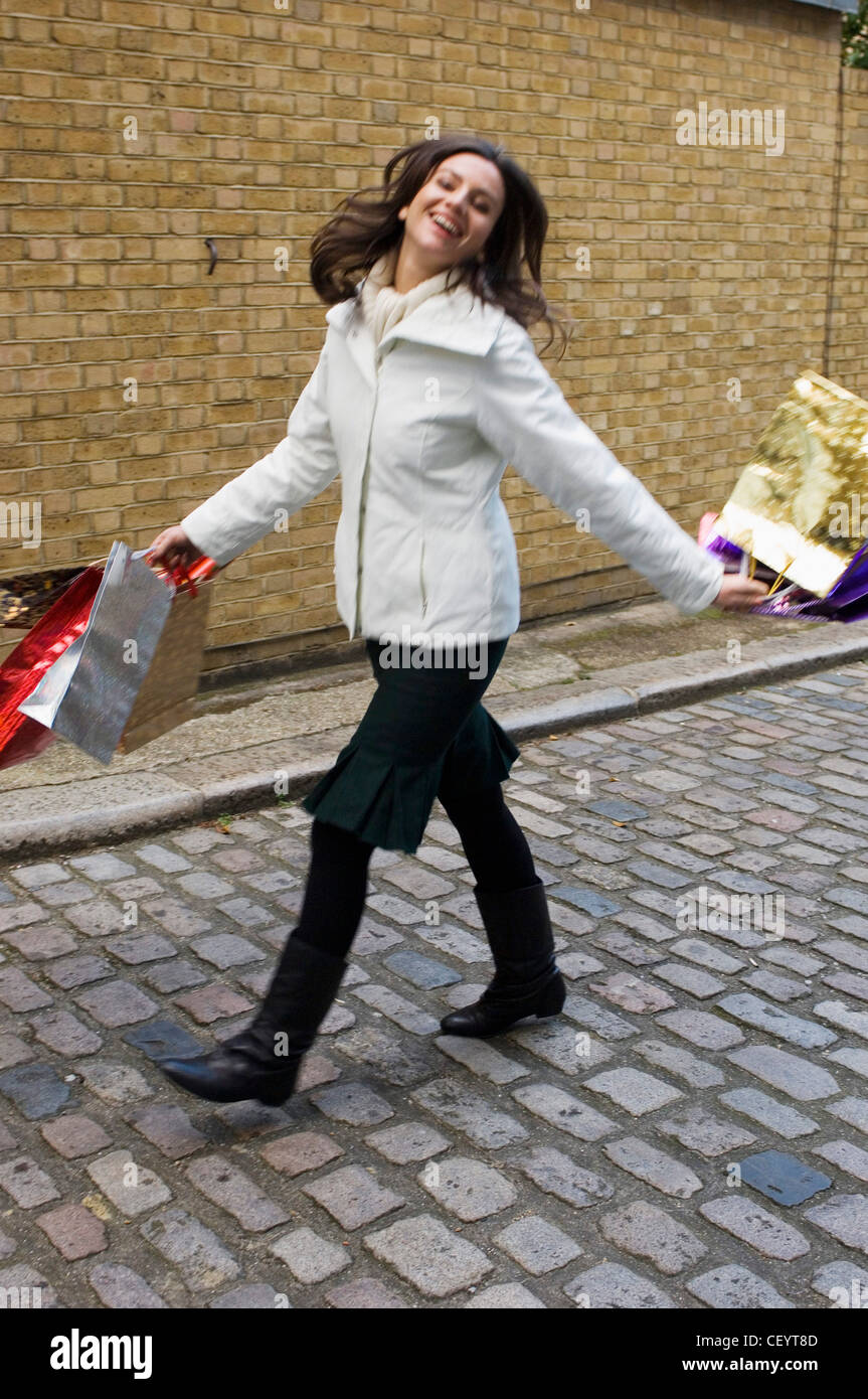 Female wearing cream polo neck jumper, cream jacket, dark green skirt ...