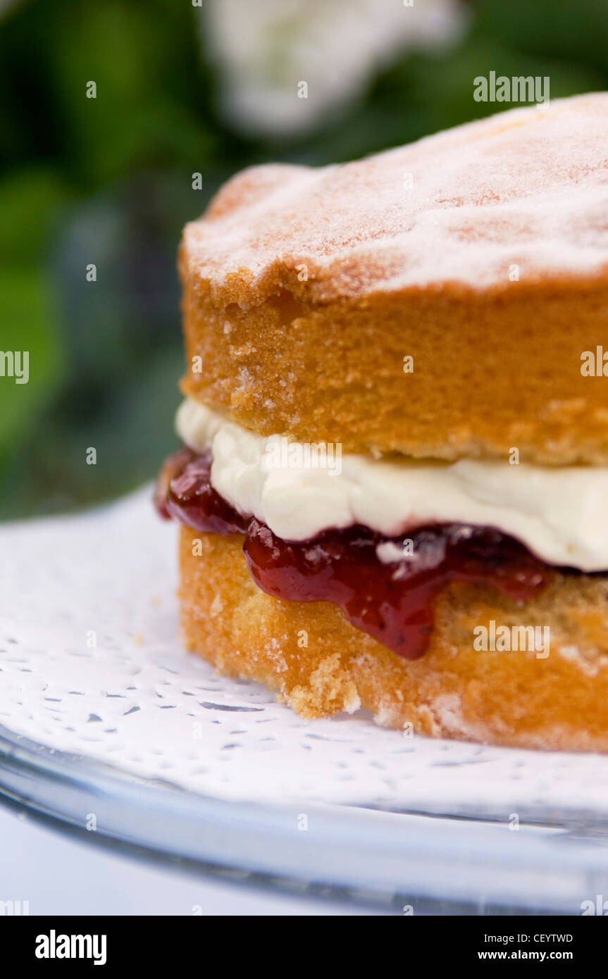 An English cream tea Victoria sponge cake with strawberry jam and cream ...