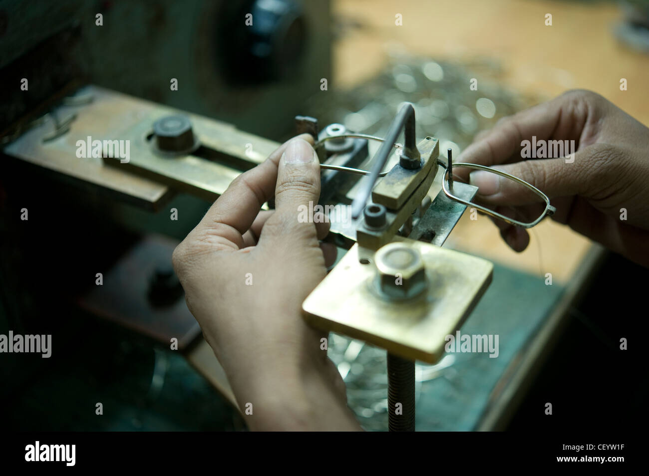 Man polishing and setting the frames of a glass/specs Stock Photo - Alamy
