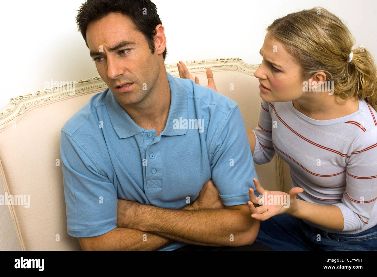 Couple sitting on sofa arguing Stock Photo - Alamy