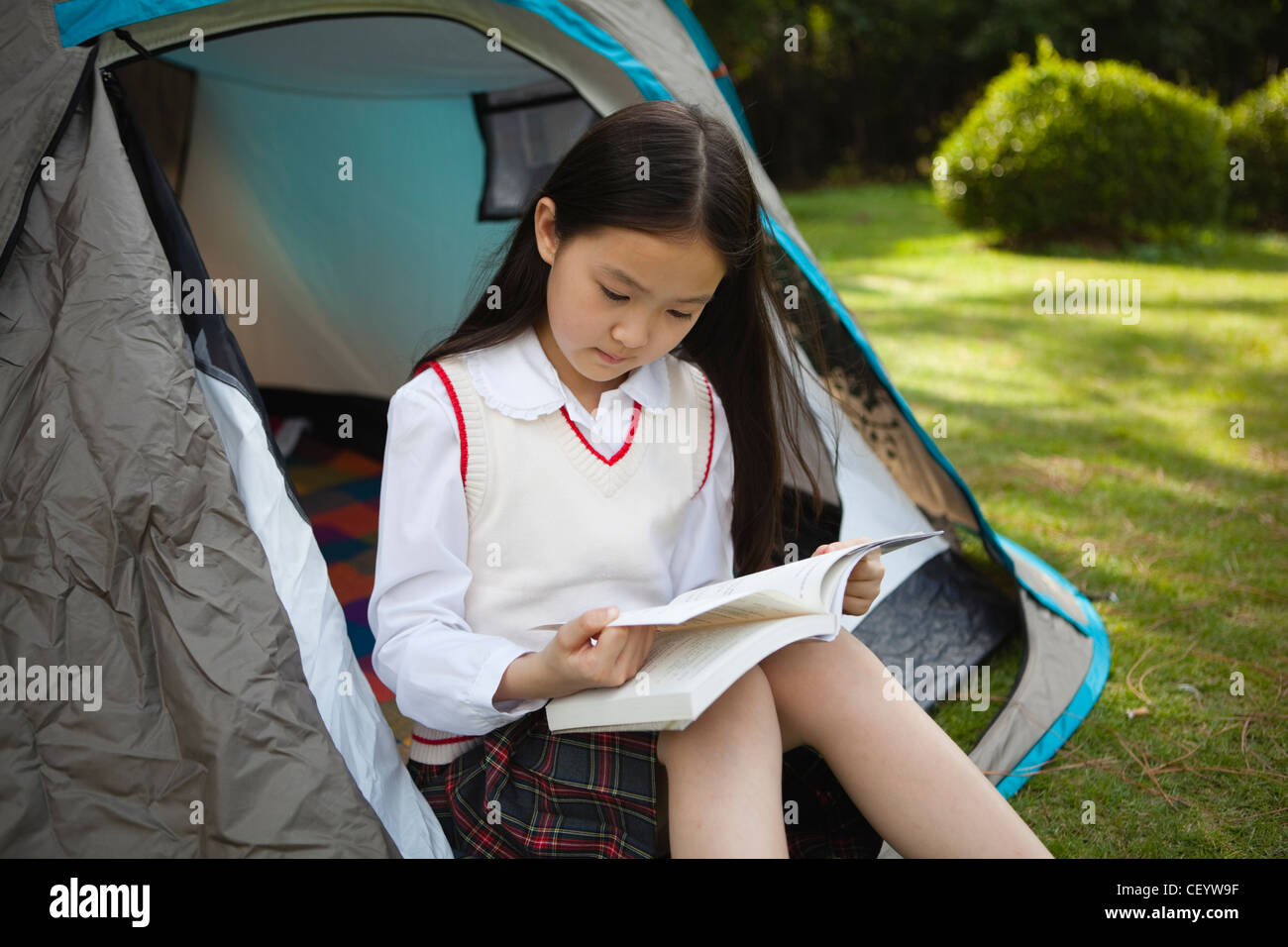 little girl reading in a tent Stock Photo - Alamy