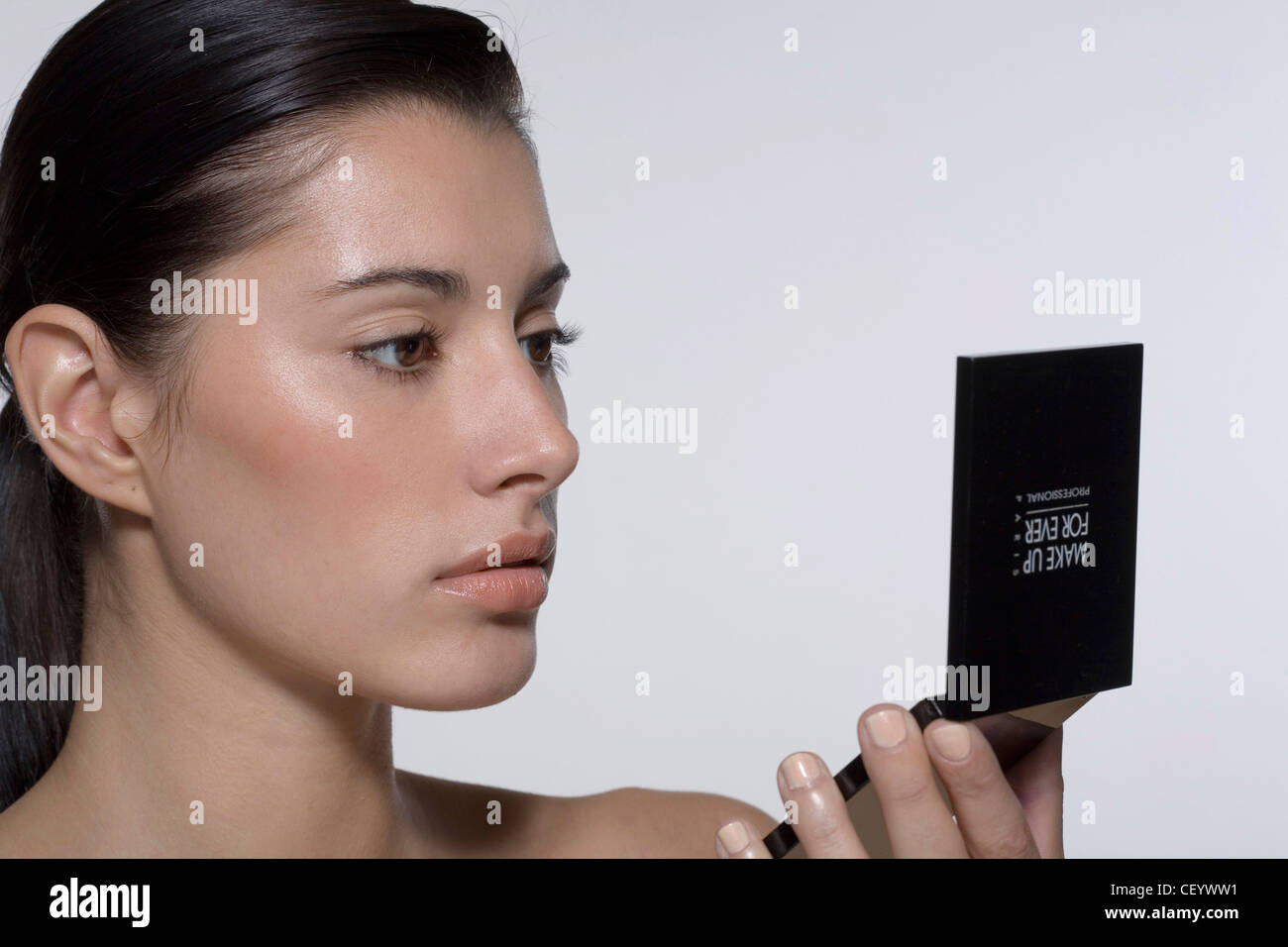 Female looking in a compact mirror Stock Photo - Alamy
