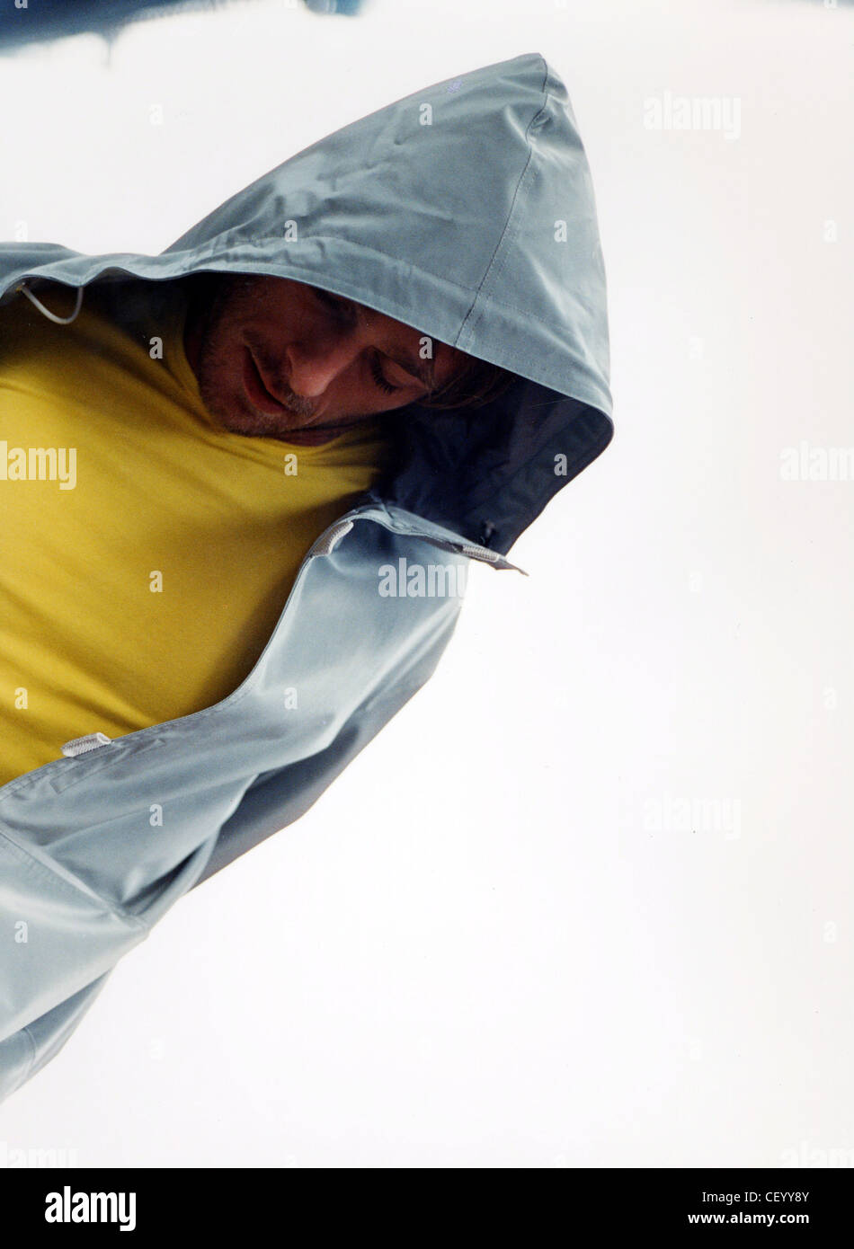 Male wearing a yellow t shirt and grey hooded jacket Stock Photo - Alamy