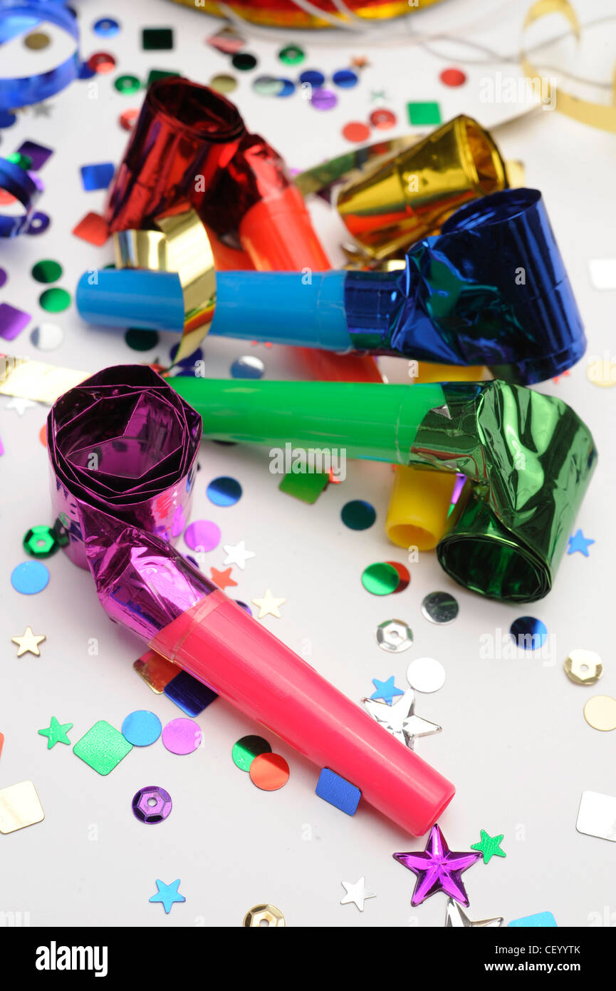 A still life image of colourful confetti, horn blowers and streamers on ...