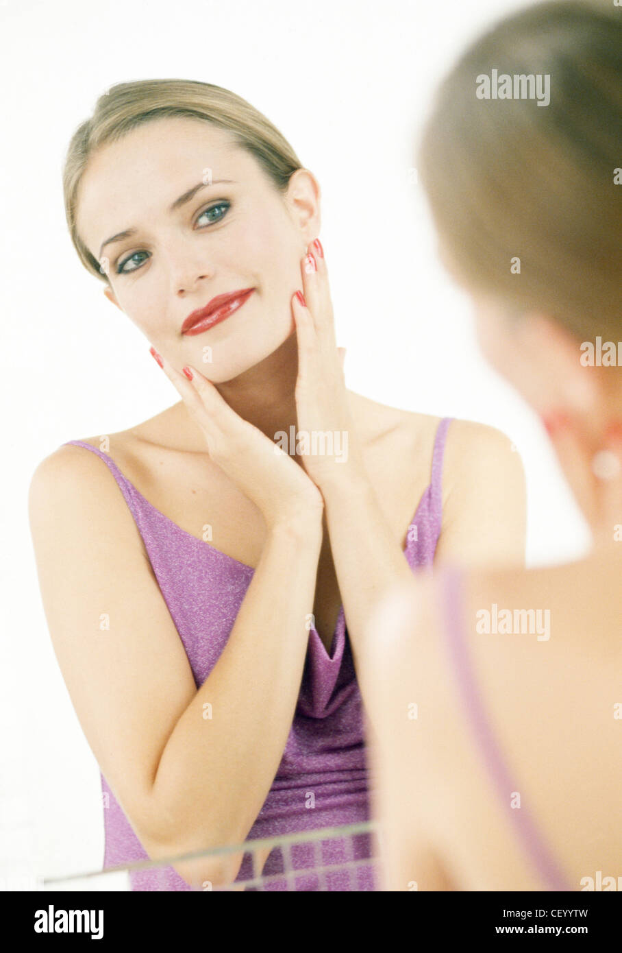 VANITY Female fair hair off her face, wearing a lilac glitter top ...