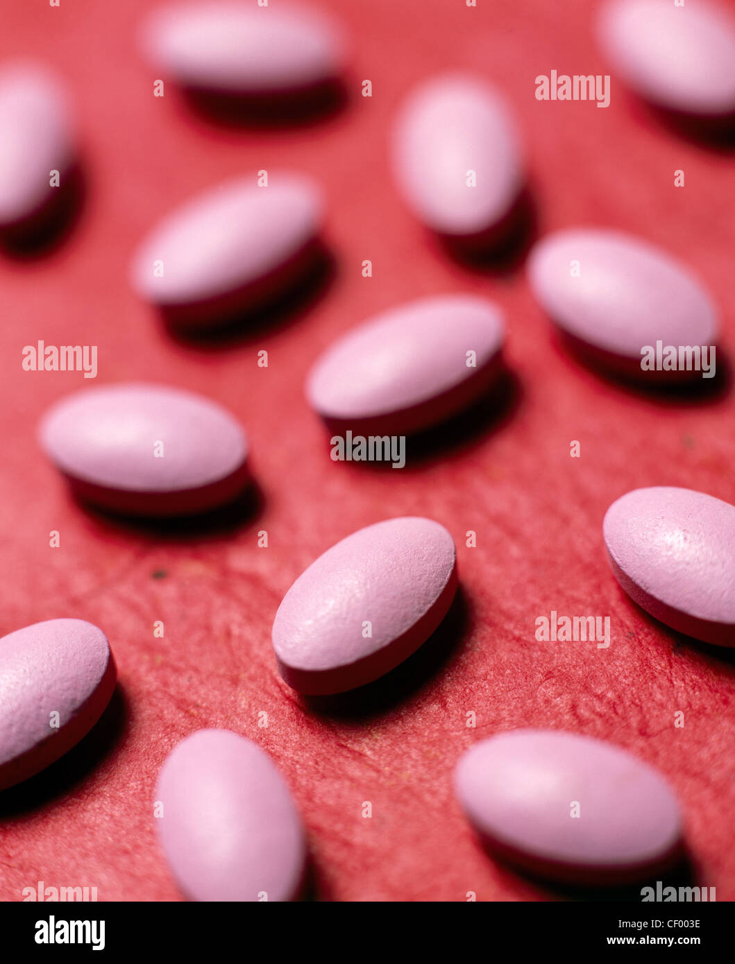 Pink homeopathic tablets on a red background Stock Photo - Alamy