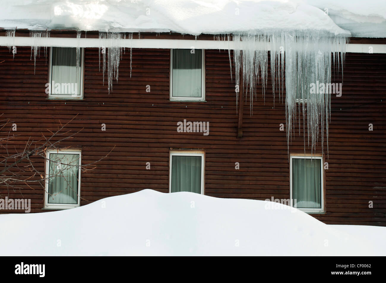 Icicles on window. Wooden house windows Stock Photo - Alamy