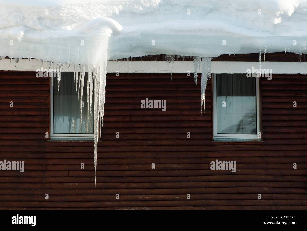 Icicles on window. Wooden house windows Stock Photo - Alamy
