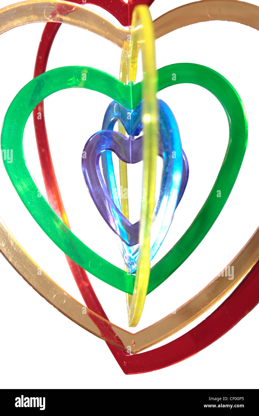 six heart shaped plastic pieces one inside the other on a white ...