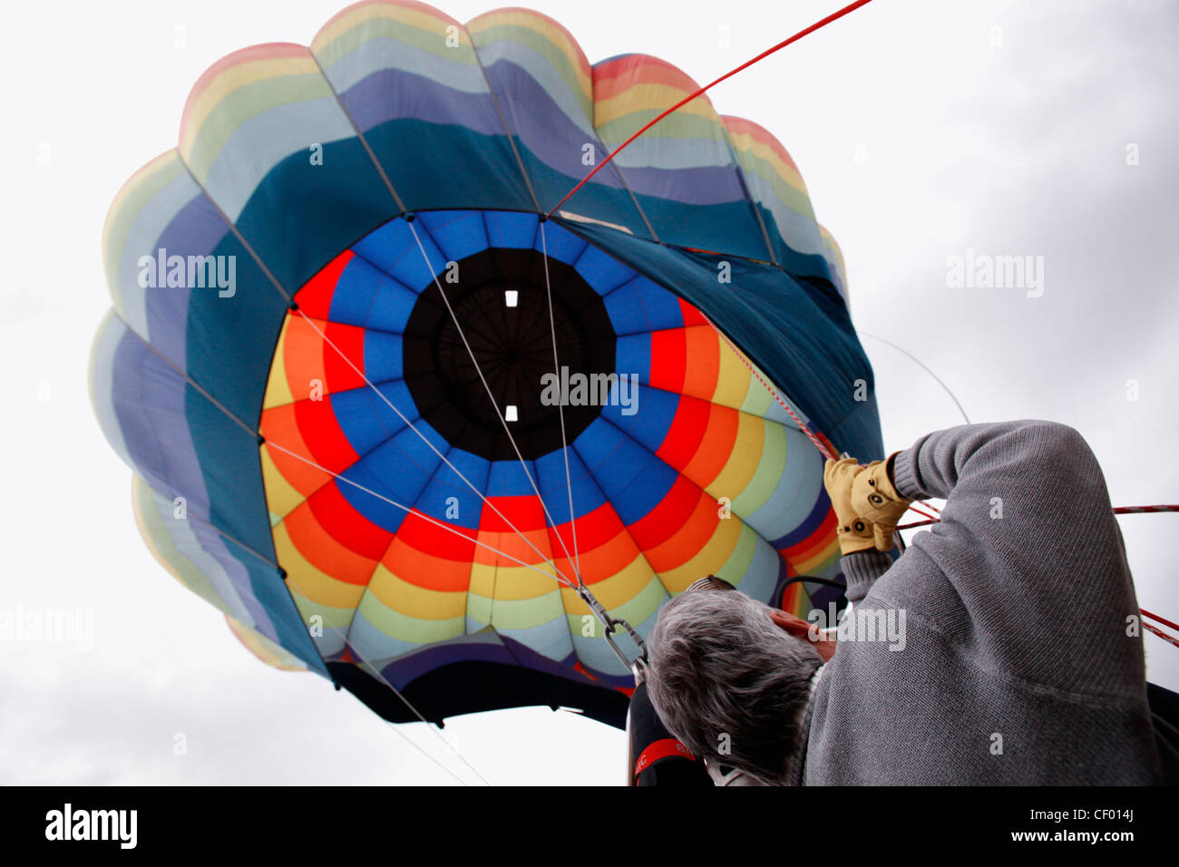 A man inflating a hot air balloon Stock Photo - Alamy