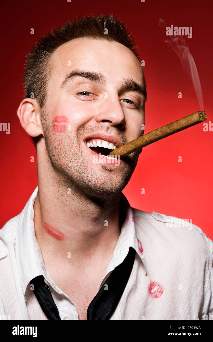 portrait of young confident man smoking cigar Stock Photo - Alamy