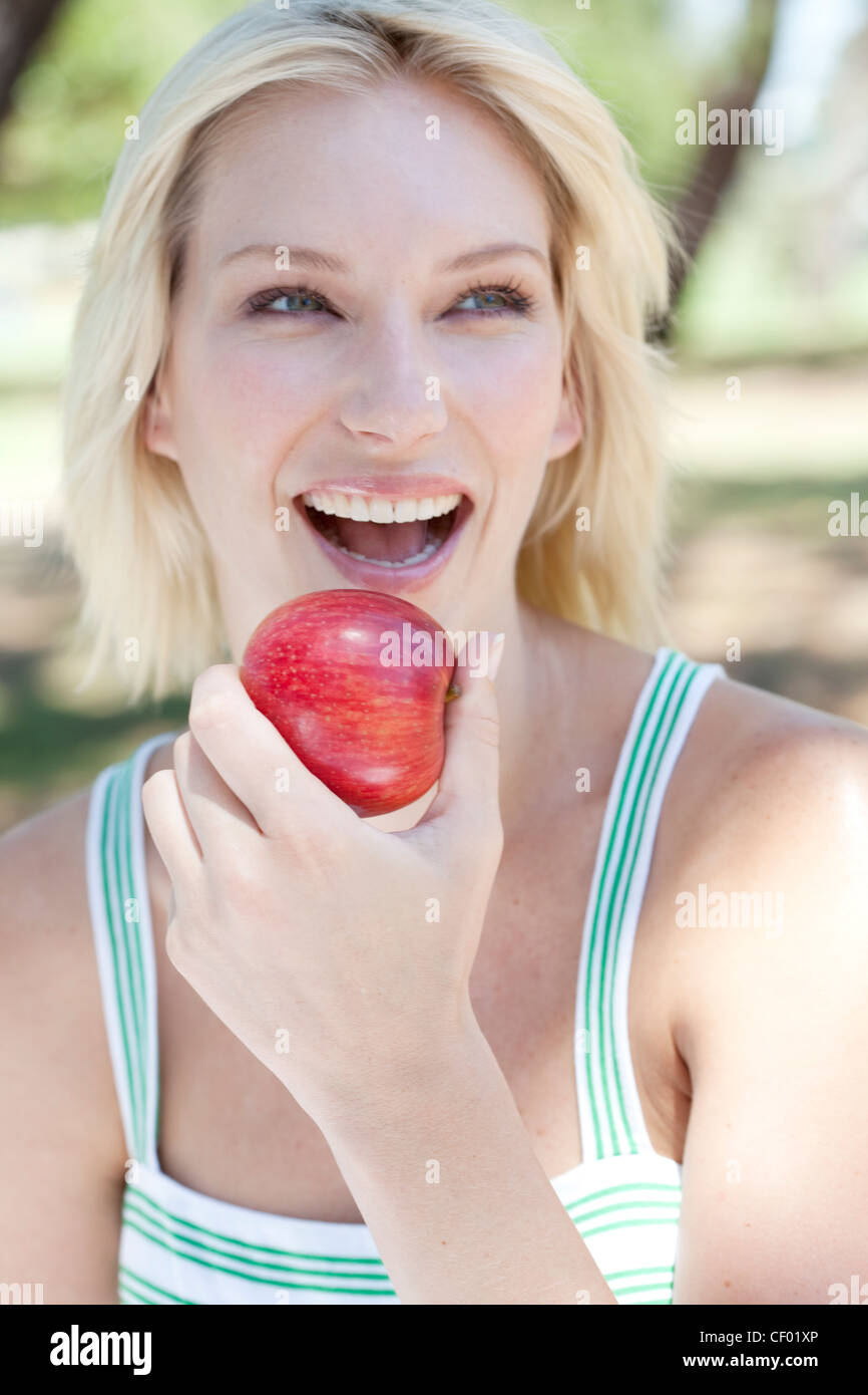 Female eating apple Stock Photo - Alamy