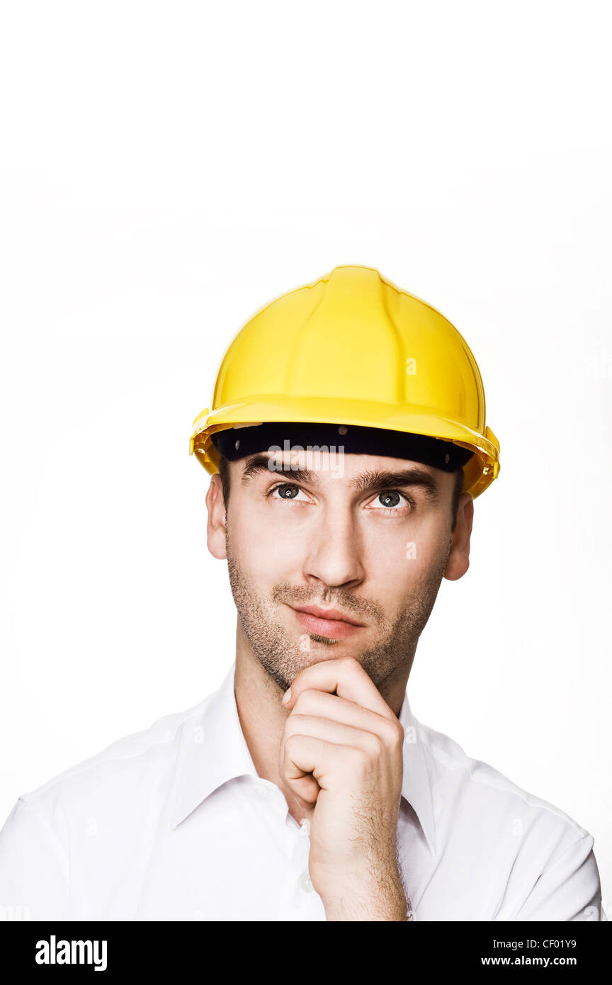 young male engineer looking up, over white background Stock Photo - Alamy