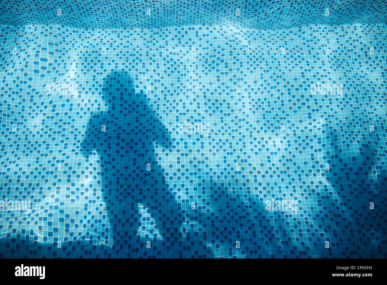A person's shadow at the bottom of the blue pool Stock Photo - Alamy