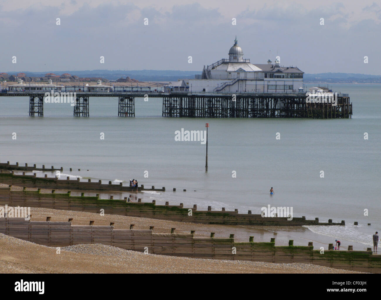 The beach and pier at Eastbourne, East Sussex. Calm sea, blue sky Stock ...